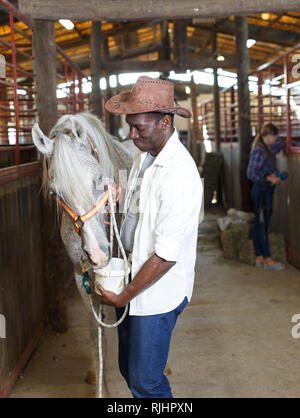 Farm workers ride work horses past an old Fort on Pedham Place farm at ...