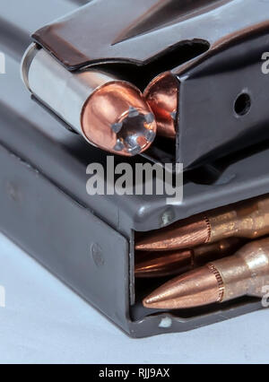 A handgun magazine loaded with .40 caliber hollow point bullets on top ...
