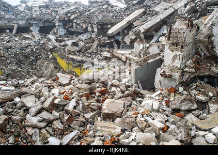 A huge pile of gray concrete debris from piles and stones of the ...