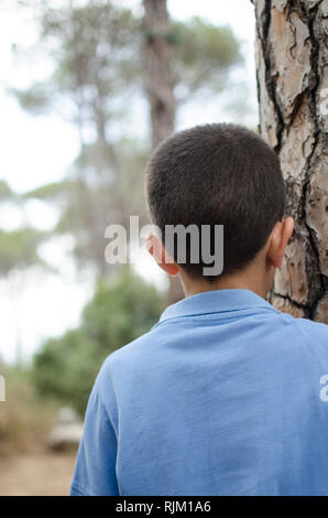 8 years old boy standing outdoors looking away Stock Photo - Alamy