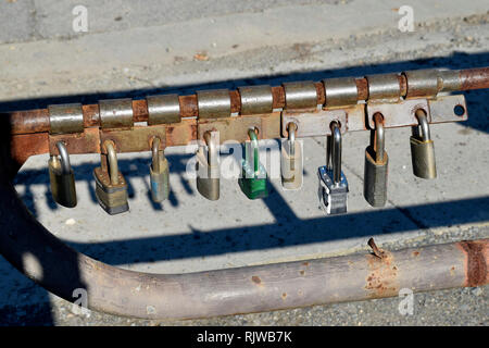 Multiple locks on a security gate. The removal of any one lock allows ...