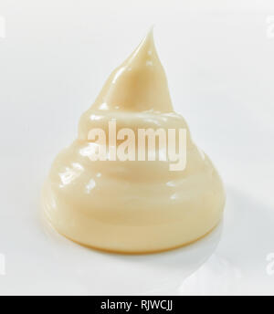 Single mayonnaise tower for stylish food presentation on a white ...