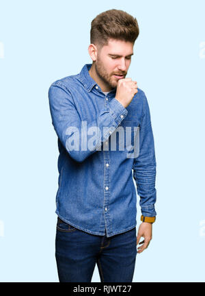 Handsome blond man with beard wearing casual sweater angry and mad ...