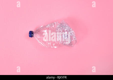 deformed plastic bottle on pink background Stock Photo - Alamy