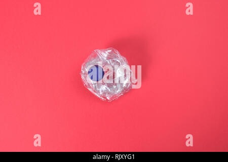 deformed plastic bottle on red background Stock Photo - Alamy