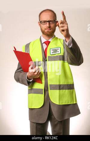male occupational health and safety officer inside factory doing Stock ...