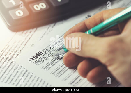 Tax Return form 1040 with USA America flag and dollar banknote, U.S ...