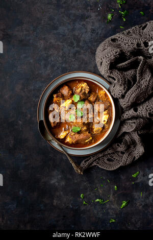 Indian mutton rogan josh with garnish (tomato, ginger julienne) and red ...