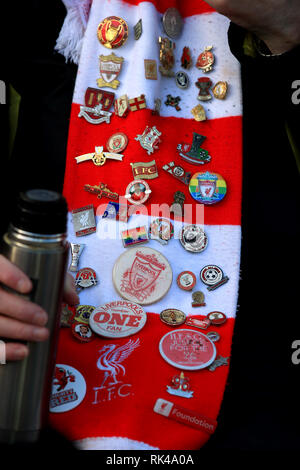 A Liverpool fan wearing a scarf and badges during the Premier League ...
