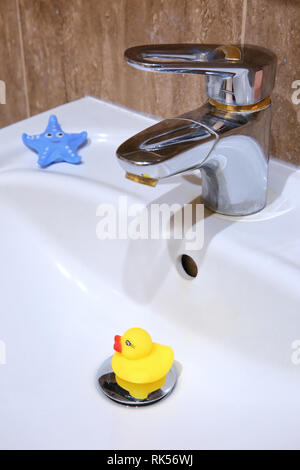 Yellow rubber duck near the blue swimming pool. Happy vacation ...