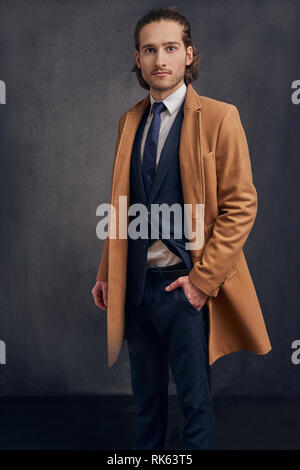 male formal fashion. professional unshaven ceo. confident boss crossed ...