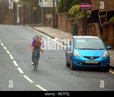Car is overtaking a cyclist on a road with many curves Stock Photo - Alamy