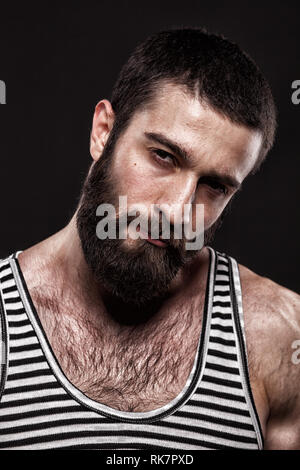 Unhappy man in striped t-shirt screaming and rubbing temples because of ...