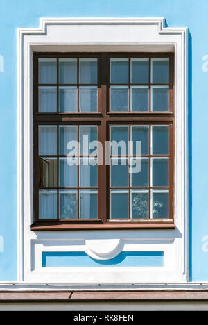 Rectangular window with a blue frame in an old country house against a ...