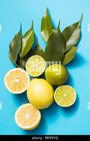 Fresh limes, on blue background Stock Photo - Alamy