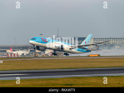 TUI Airways Boeing 787-8 Dreamliner at Manchester Airport as a family ...