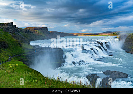Water cascades over gullfoss waterfalls on a cloudy day in Iceland at ...