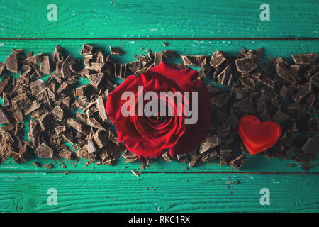 Red rosebud with chopped chocolate for St Valentine's day on a green ...