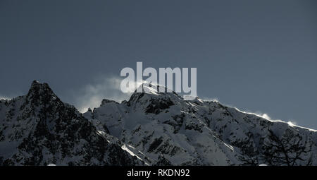 Wind blowing over snow capped mountain peaks Stock Photo - Alamy