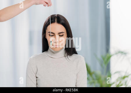 Hypnotist hypnotizing a female patient, The hand in catalepsy indicates ...