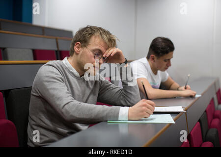 Man sitting supervised Mensa IQ test at University College London ...