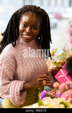 Positive delighted female person demonstrating her smile while taking ...