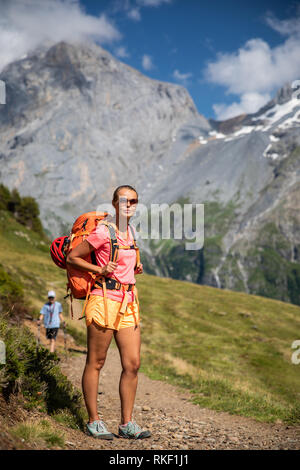 Pretty, female hiker/climber in a lovely alpine setting of Swiss Alps ...