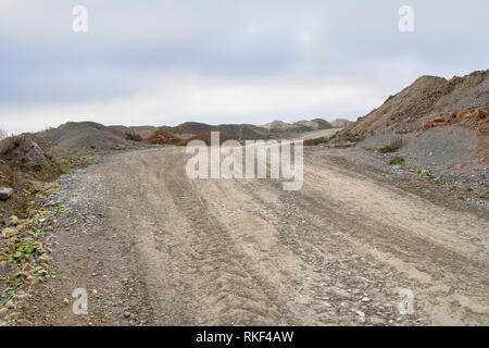 dirt road and spoil heaps at a quarry Stock Photo - Alamy