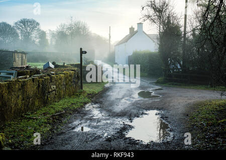 Country cottage in a misty Welsh valley wooded landscape in October ...