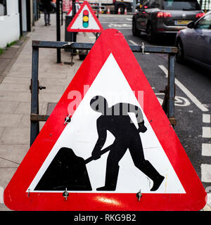 roadworks with men at work sign and traffic cones Stock Photo ...