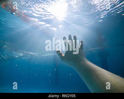 first person view. drowning man under water. air bubbles. legs Stock ...