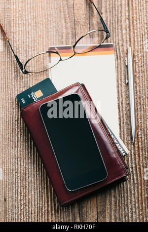 Leather wallet with dollar banknotes, credit card and receipt, glasses ...