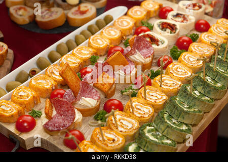 Mini canapes food. Beautiful decorated catering banquet, wooden stands ...