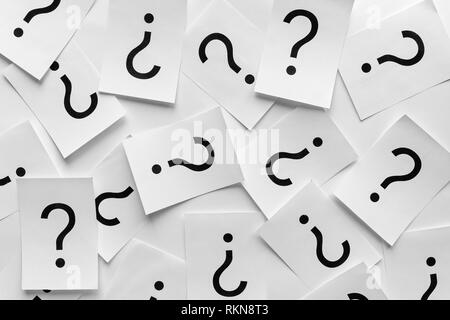 Randomly scattered question marks on white paper Stock Photo - Alamy