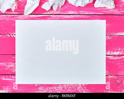 crumpled pink rectangular sheet of paper on a white background, copy ...