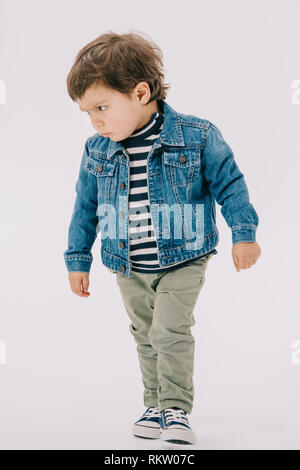 little boy in a blue jacket in a snowy forest crying on a cold day ...