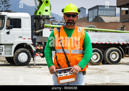 Concrete pump operator with remote control for boom pump truck at ...