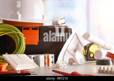 Office table of electrical engineer with installation project and tools ...
