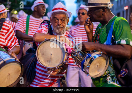 Samba drummer amongst other musicians at a carnival block party in the ...