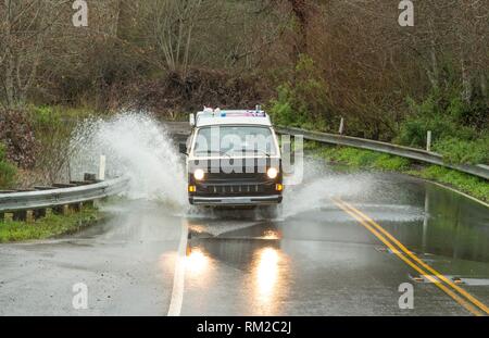 Car driving through deep puddle Stock Photo - Alamy