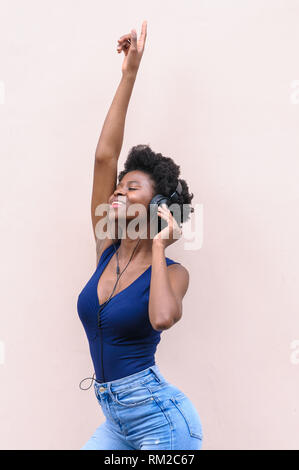 Enjoying Life. Beautiful happy African ethnicity girl with lush dark ...