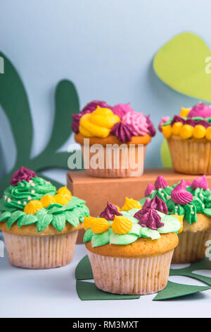 Creative dessert muffin with colorful cream decoration Stock Photo - Alamy