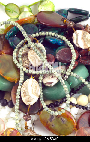 A vertical shot of a lot of stones on the beach and sea with cloudy sky ...