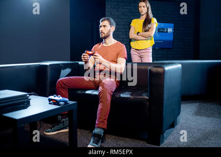 Young woman angry at her boyfriend playing video games with gaming ...