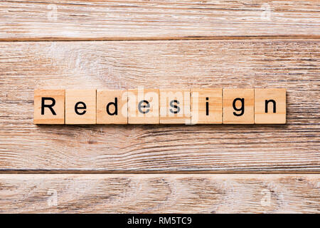 REDESIGN word written on wood block. REDESIGN text on wooden table for ...