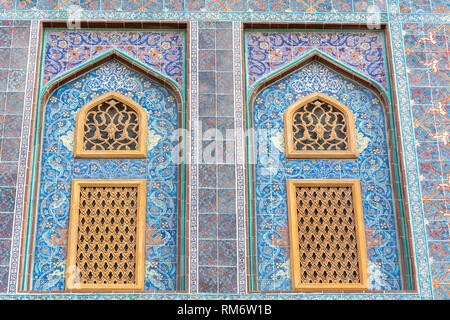 Traditional Arabic mashrabiya window on a tiled wall enclosed with ...