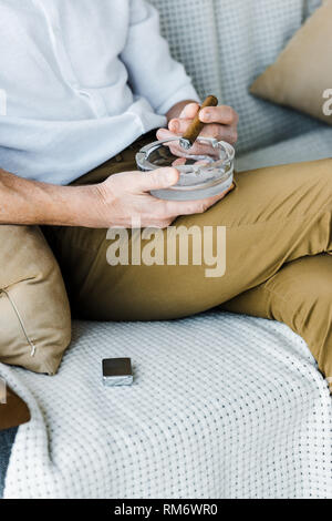 senior man holding sigar and ashtray in hands Stock Photo - Alamy