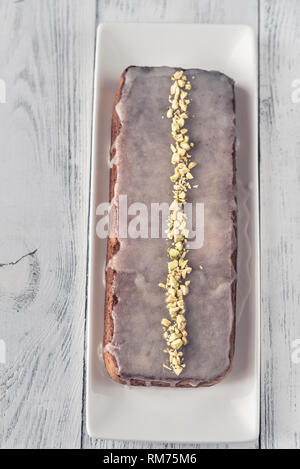 Lemon cake with icing decorated with pistachios: top view Stock Photo ...