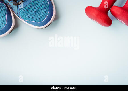 Sneakers and dumbbells on the solid backdrop. Keep fit athletic and ...