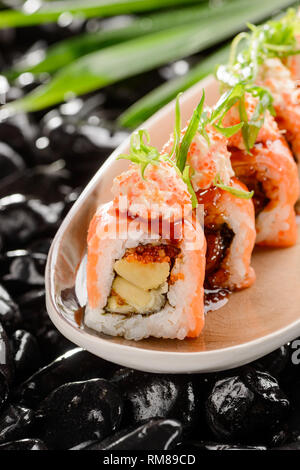 Sushi roll set with shrimp, flying fish reo, avocado and cucumber on a ...